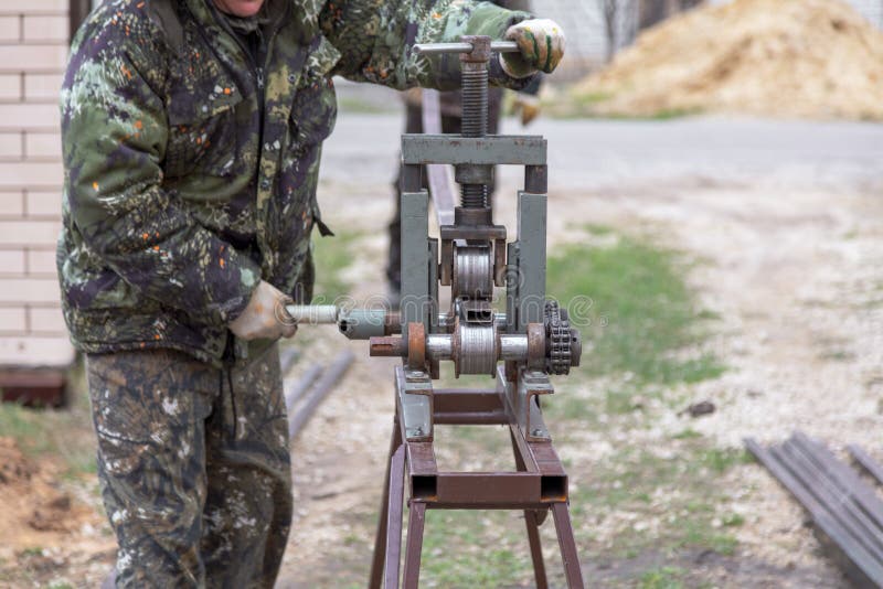 Workers Bend Metal in a Pipe Bender. Stock Photo - Image of steel ...