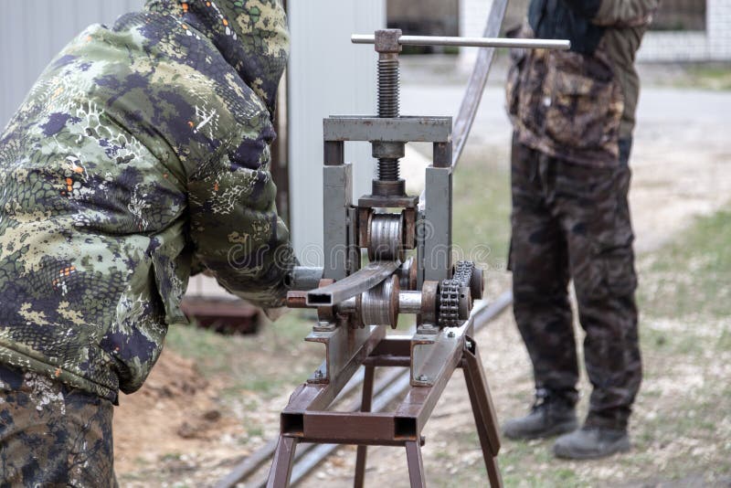 Workers Bend Metal in a Pipe Bender. Stock Image - Image of material ...