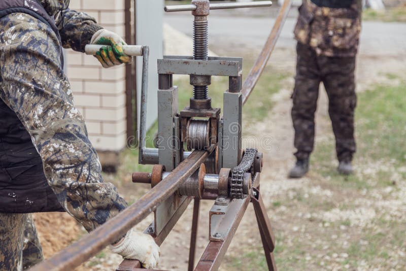 Workers Bend Metal in a Pipe Bender. Stock Image - Image of metal ...