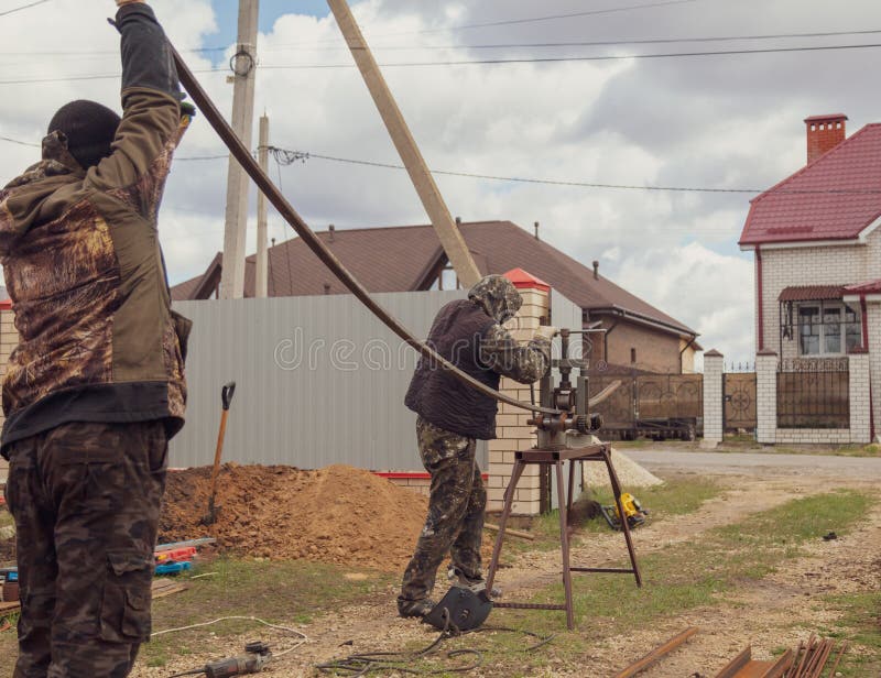 Workers Bend Metal in a Pipe Bender. Stock Photo - Image of worker ...