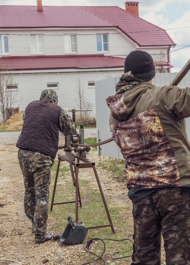 Workers Bend Metal in a Pipe Bender. Stock Photo - Image of ...