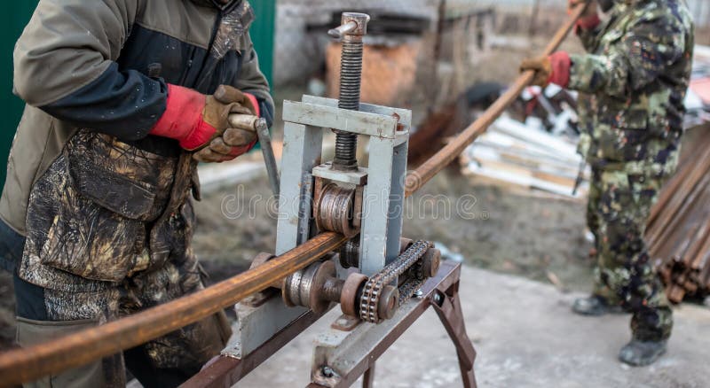 Workers Bending Metal at a Construction Site. Technology Stock Photo ...