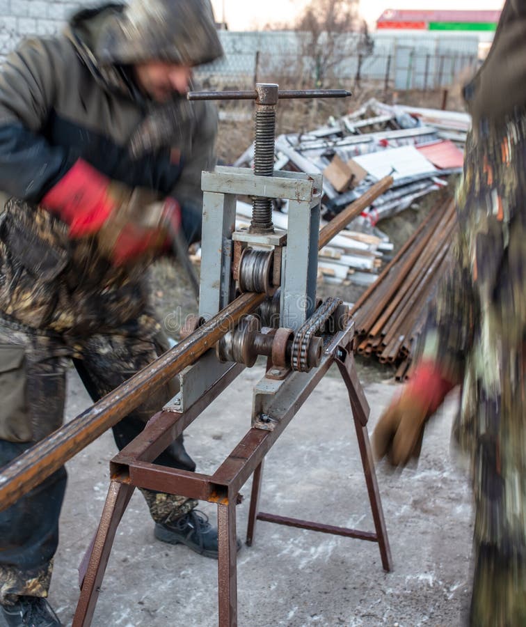 Workers Bending Metal at a Construction Site. Technology Stock Image ...