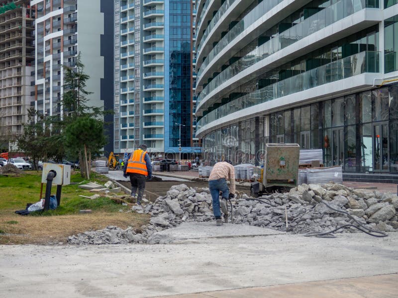 Workers Break Off Concrete. Hard Work. People are Reconstructing the ...