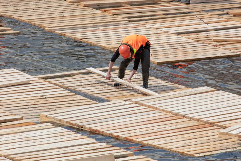 Workers Build a Dam of Wood on the River Stock Photo - Image of ...