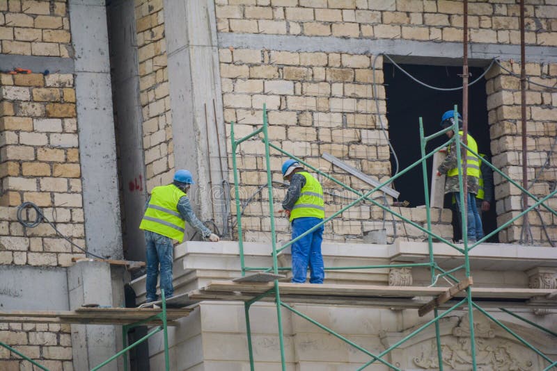 Working builders editorial photo. Image of builders, facing - 49925961