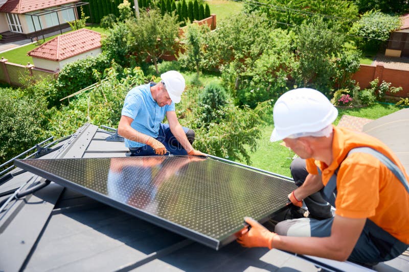 Technicians Carrying Photovoltaic Solar Module while Installing Solar ...