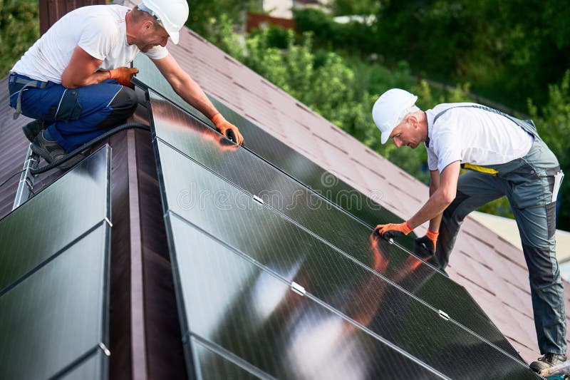Technicians Carrying Photovoltaic Solar Module while Installing Solar ...