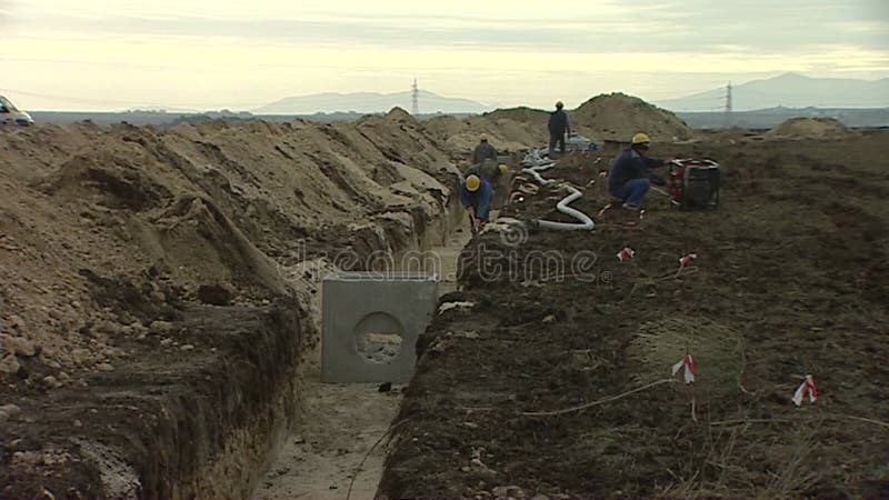 Workers in cable ditch stock footage. Video of equipment - 78023142