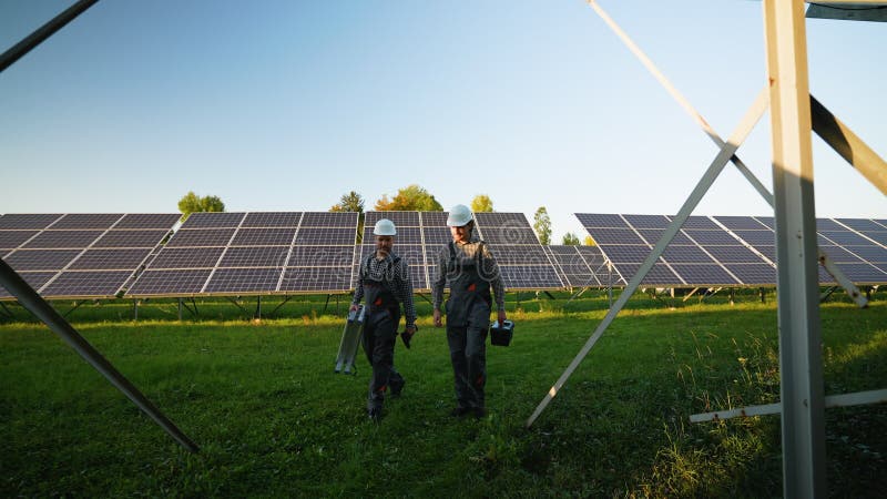 Workers Carry Tools Across Solar Panel Field Stock Footage - Video of ...