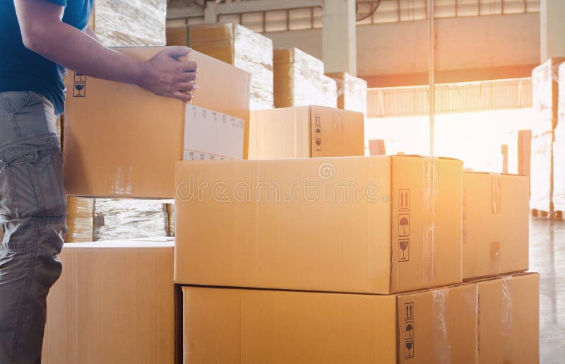 Workers Carrying a Package Boxes Stack on Pallets. Cartons, Cardboard ...