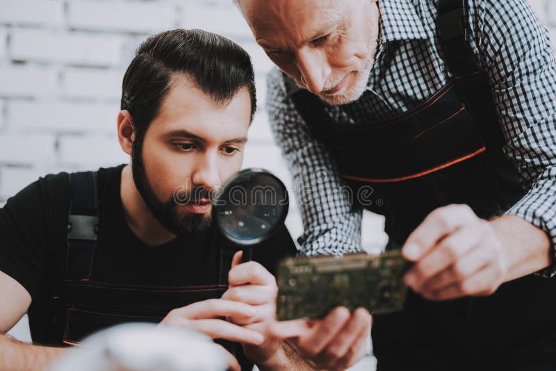 Workers Check Hardware with Magnifying Glass. Stock Photo - Image of ...