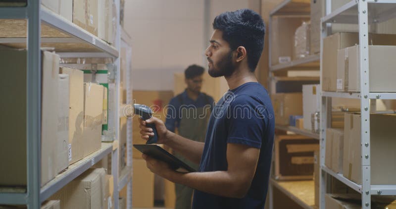 Workers Checking Boxes in a Distribution Center Stock Photo - Image of ...