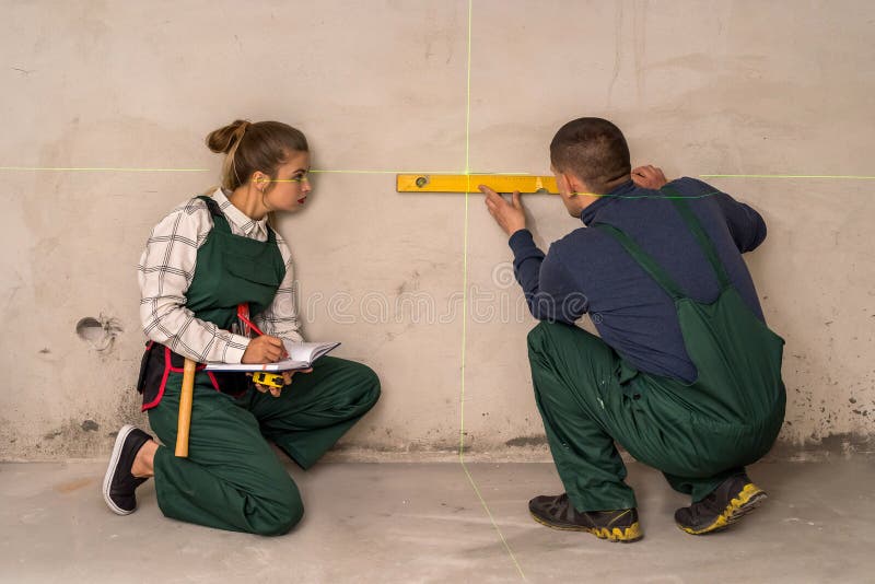 Workers Checking Walls with Laser Level Tool Stock Photo - Image of ...