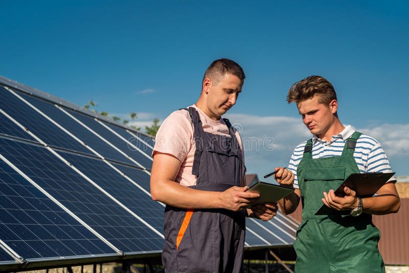Workers Checking Work of Solar Panel Station and Discussing with Tablet ...