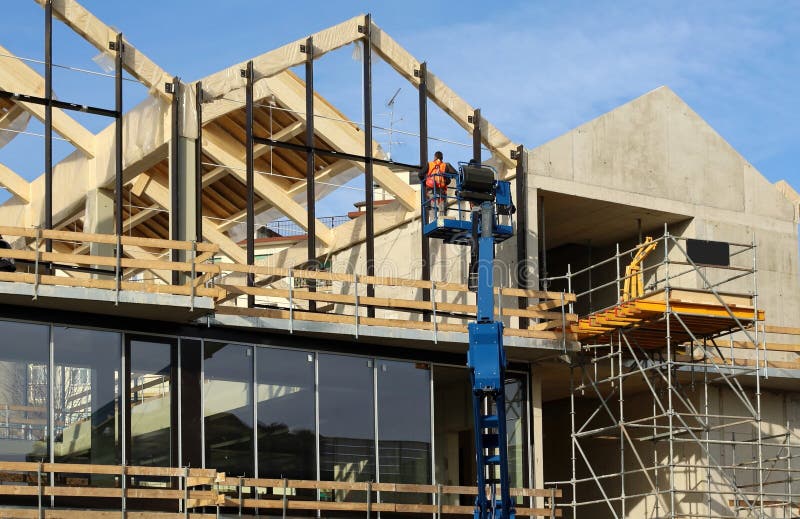Workers on a Cherry Picker in Front of New Building Under Construction ...