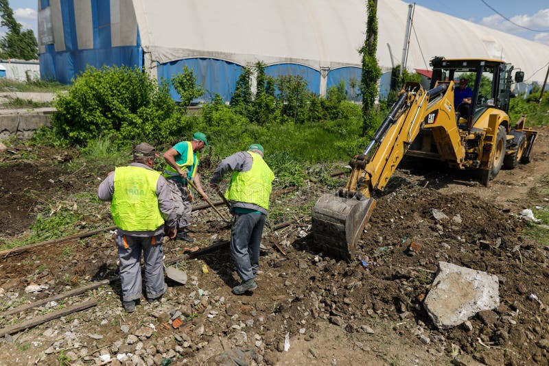 Workers Clean an Area from Vegetation and Railroad Debris for Future ...