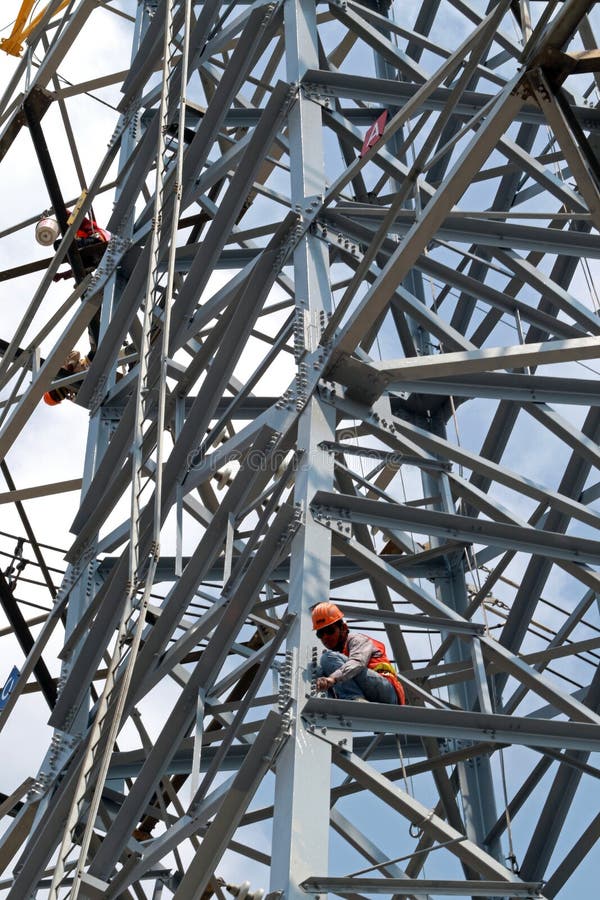 Workers Climb As Work on High Voltage Electric Post. Editorial Stock ...