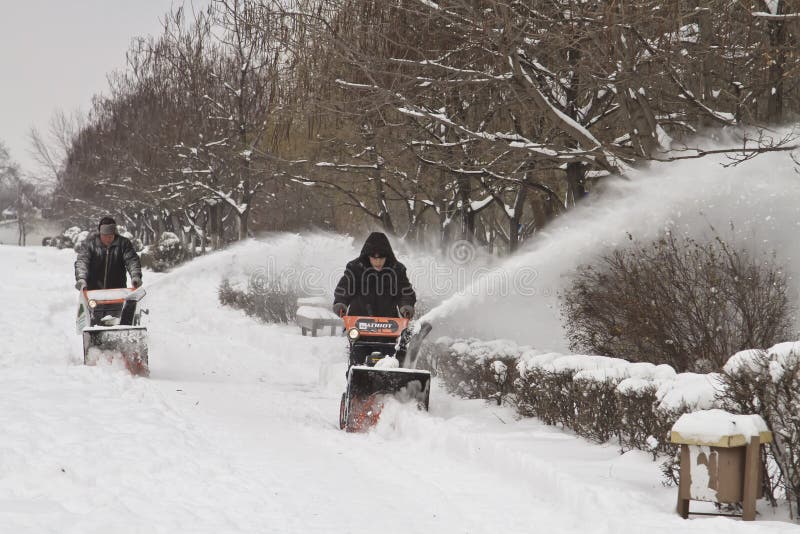Workers of Communal Services Remove the Snow from the Sidewalk with the ...
