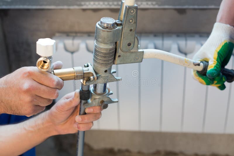 Workers Connecting Pipes with a Tap in the Stock Photo - Image of ...