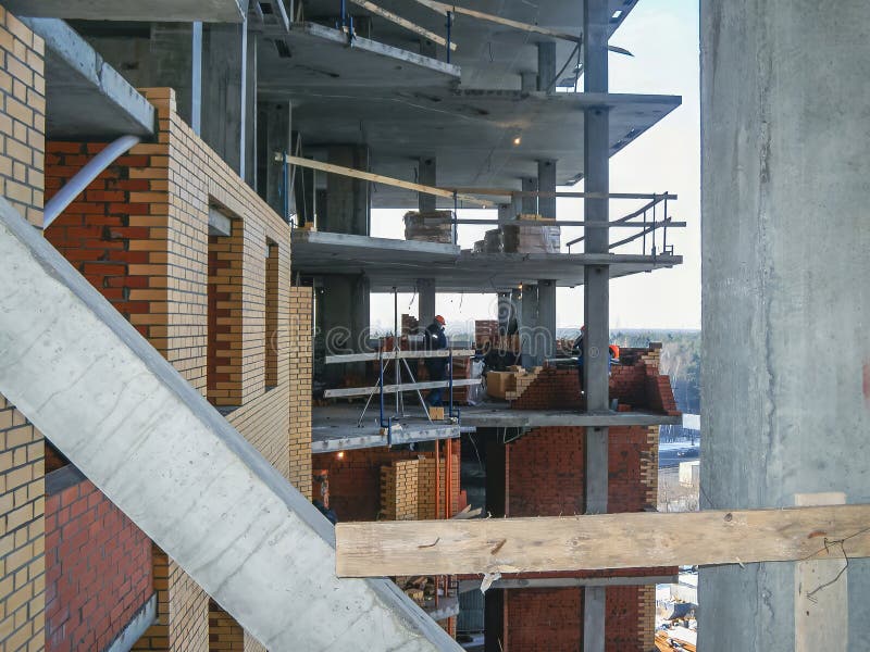 Workers Construct a Building, Showcasing Brickwork and Concrete ...