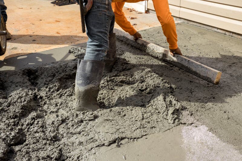 The Workers Construct a New Sidewalk Adjacent To the House by Pouring ...