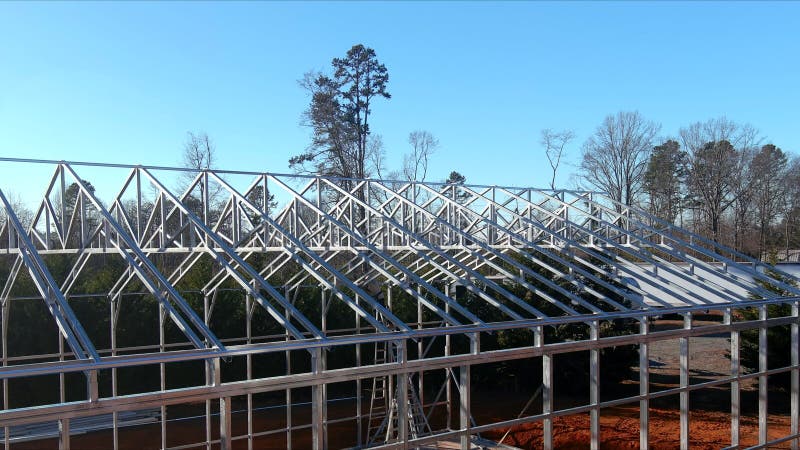 Steel Frame Construction of a New Building in a Wooded Area Under Clear ...