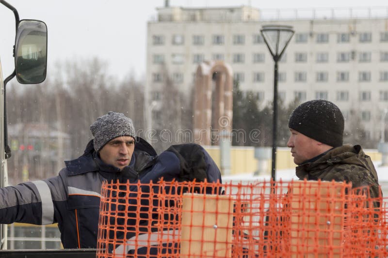 Two Workers Talk on the Assembly Site Stock Photo - Image of blue ...