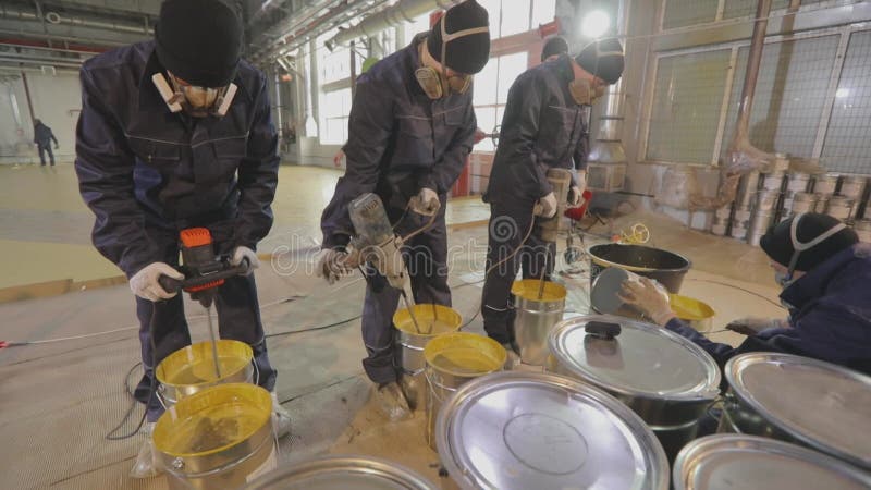 Working Process at a Construction Site. Workers Stir Up the Bulk Floor ...