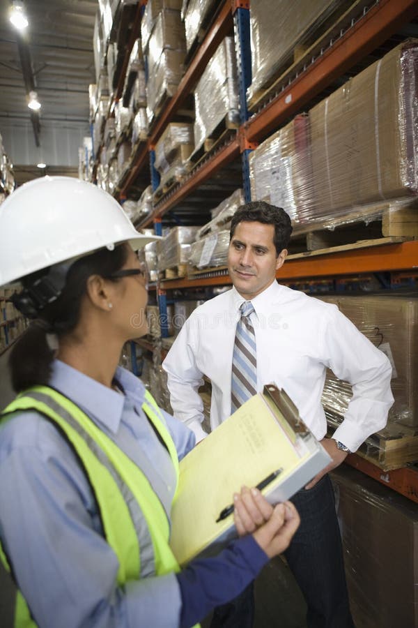 Workers in Discussion at Warehouse Stock Photo - Image of four ...