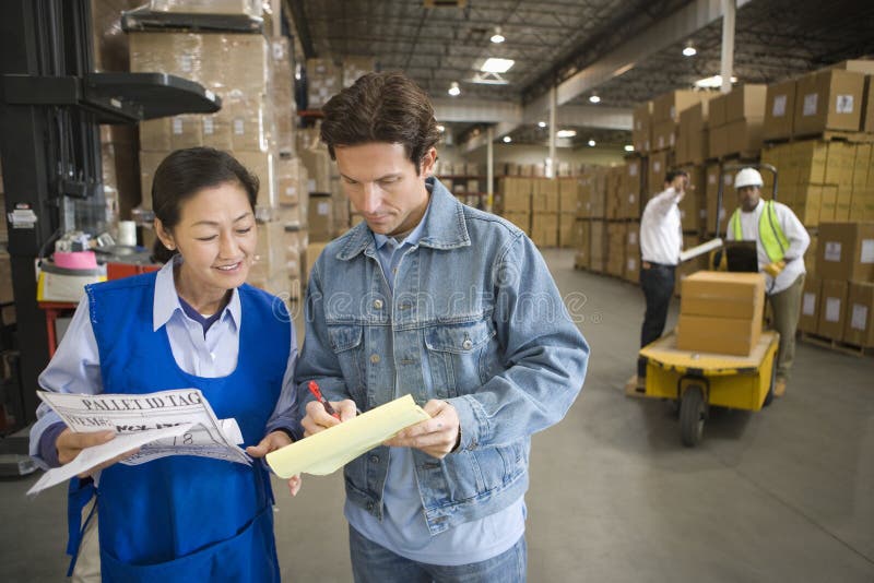 Workers in Discussion at Warehouse Stock Photo - Image of four ...