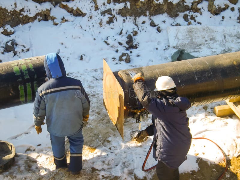 The Workers Engaged in the Construction of the Pipeline. Welders Build ...