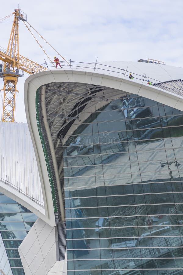 Workers are Engaged in the Installation of the Roof on a High-rise ...