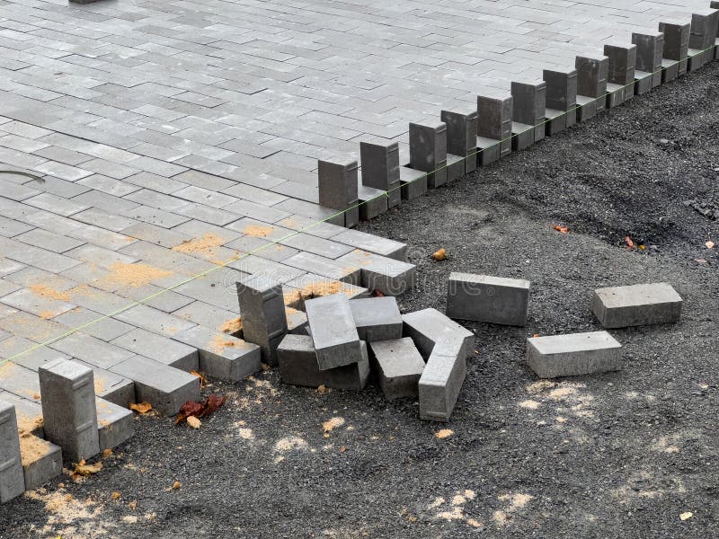 Workers are Engaged in Laying Paving Stones To Create a Durable Pathway ...