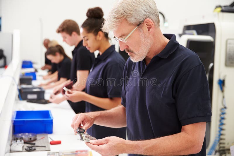 Factory Workers Checking Goods on Production Line Stock Image - Image ...