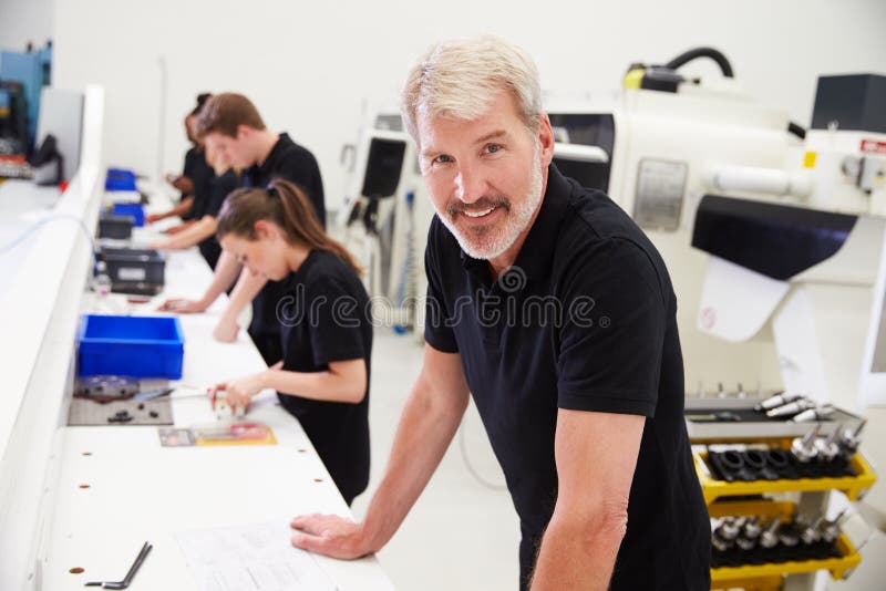 Workers in Engineering Factory Checking Component Quality Stock Photo ...