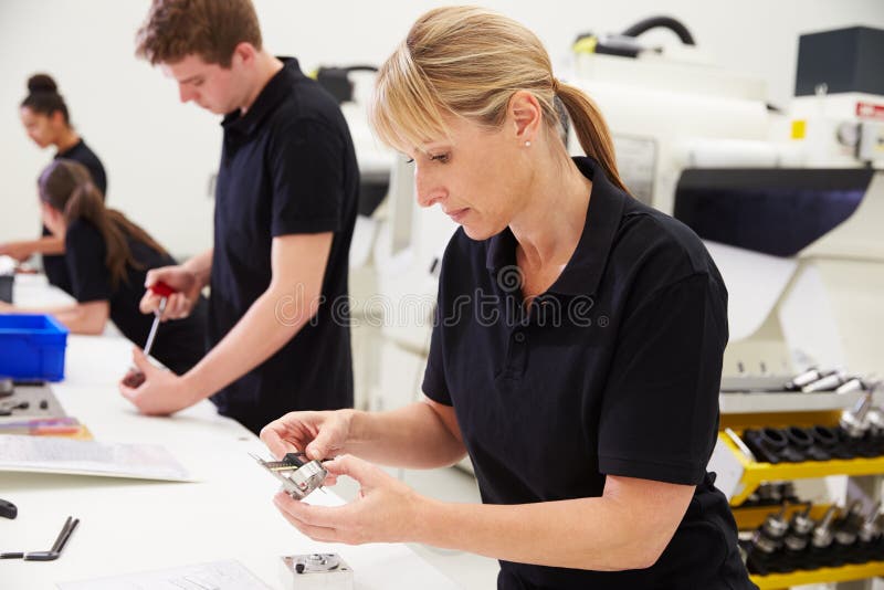 Factory Workers Checking Goods on Production Line Stock Image - Image ...