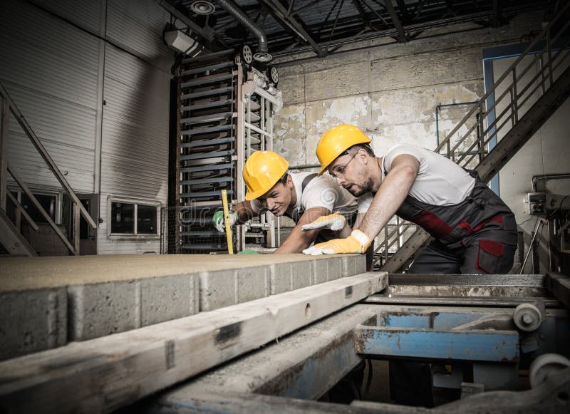 Two workers on a factory stock image. Image of equipment - 40984605