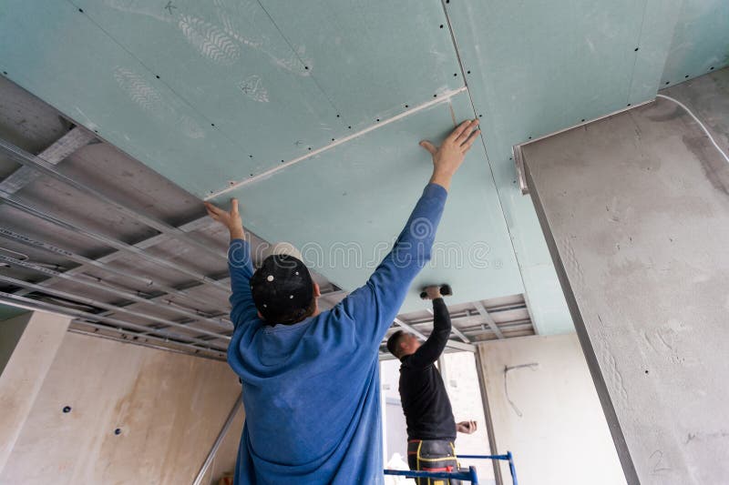 Man Fitting Plasterboard Ceiling Stock Image - Image of carpenter ...