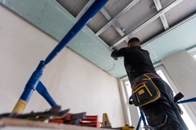 Man Fitting Plasterboard Ceiling Stock Image - Image of carpenter ...