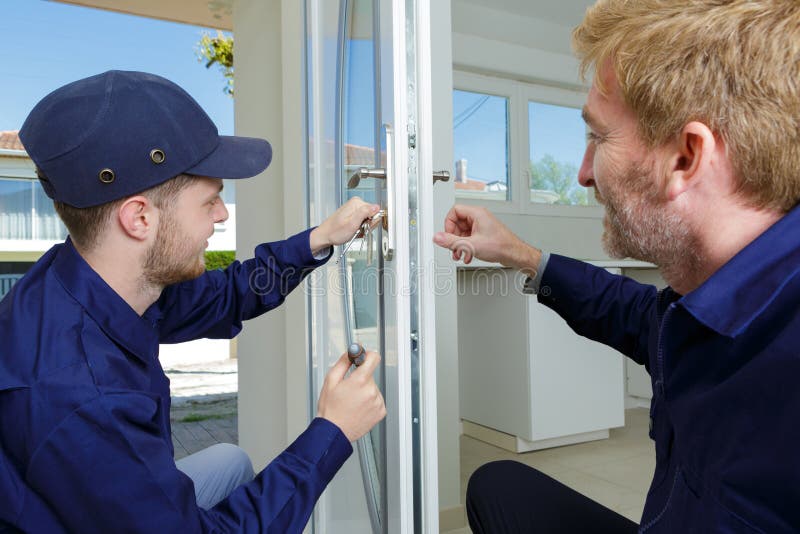 Workers fitting a window stock photo. Image of house - 261516226