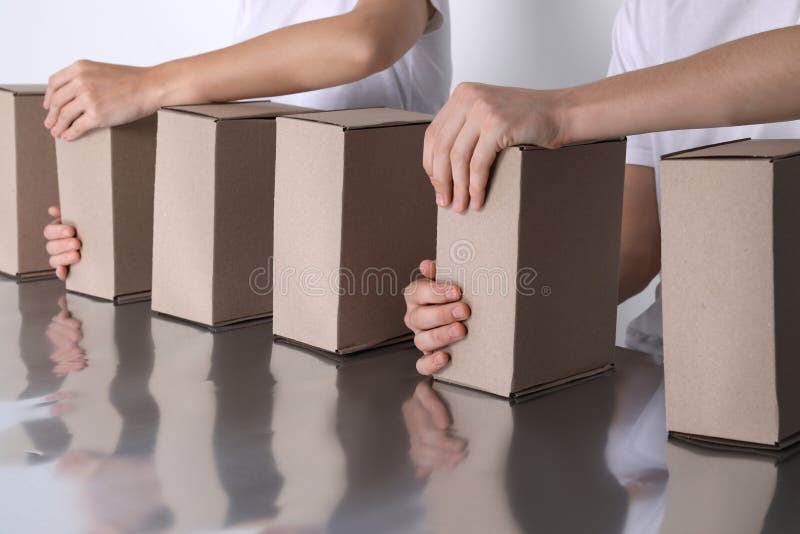 Workers Folding Cardboard Boxes at Table, Closeup. Production Line ...