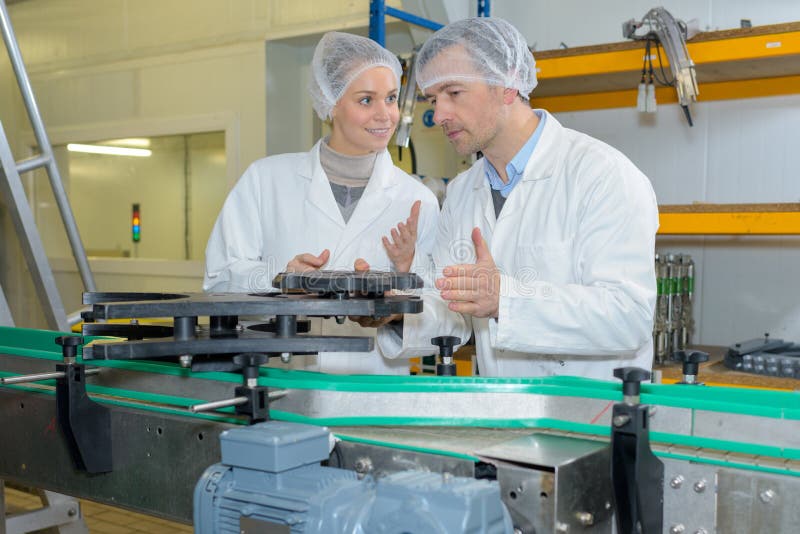 Workers in Food Production on Machine Stock Image - Image of workwear ...