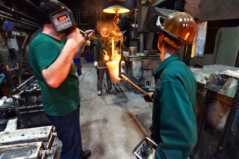Workers in a Foundry Casting a Metal Workpiece - Safety at Work and ...
