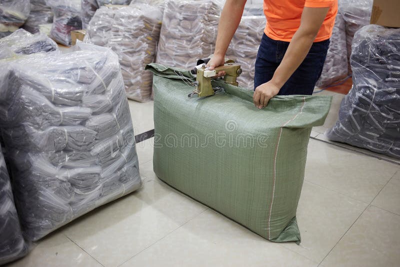 Workers in a Garment Factory are Loading and Sorting Clothes Stock ...