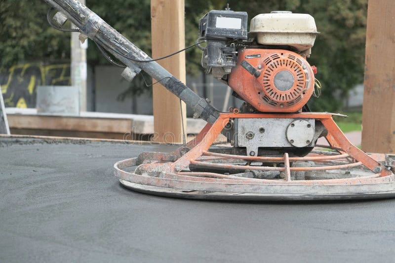 The Workers Grind the Concrete Floor at the Construction Site Stock ...