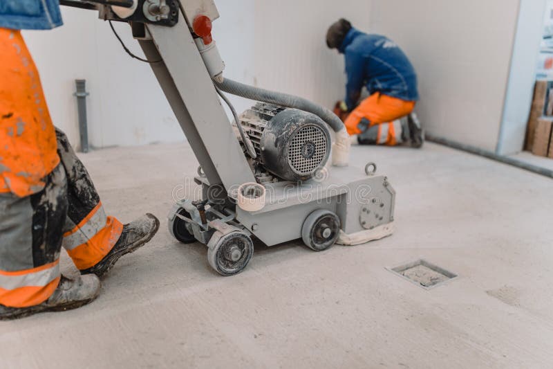 Workers Grind the Concrete Floor at the Construction Site Stock Image ...