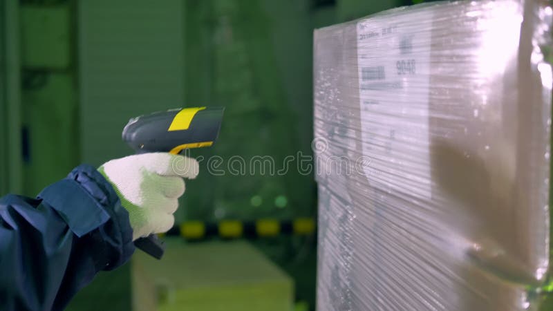 Bar Code Scanner. Worker Use Bar Code Scanner for Checking Goods at a ...