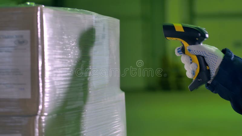 Bar Code Scanner. Worker Use Bar Code Scanner for Checking Goods at a ...