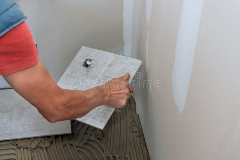 Workers Hands with Applying Tile Adhesive To the Floor Process of ...